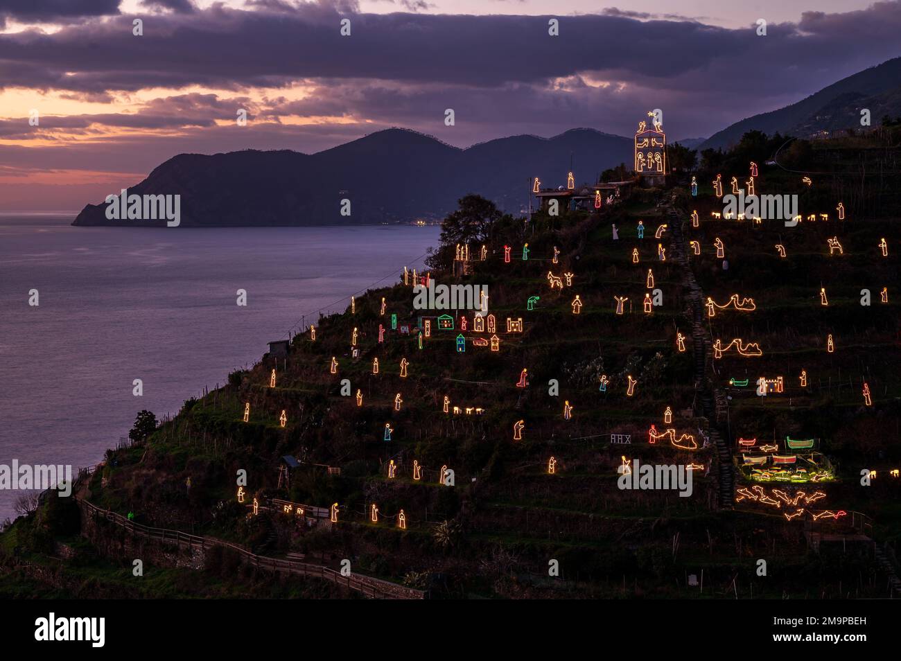Illuminated Nativity Scene on the top of a Hill over the village of ...