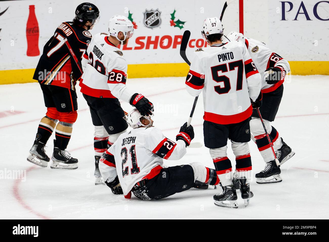 Ottawa Senators forward Mathieu Joseph, center, sits on the floor after ...