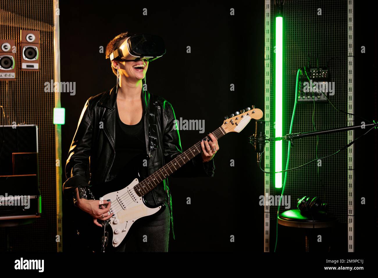 Guitarist with virtual reality headset enjoying rock concert simulation ...