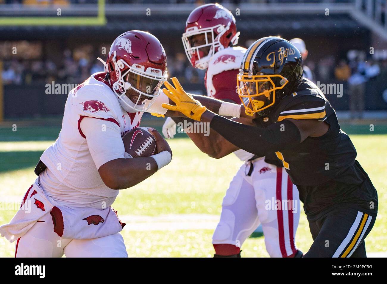 Arkansas quarterback KJ Jefferson, left, runs past Missouri defensive ...