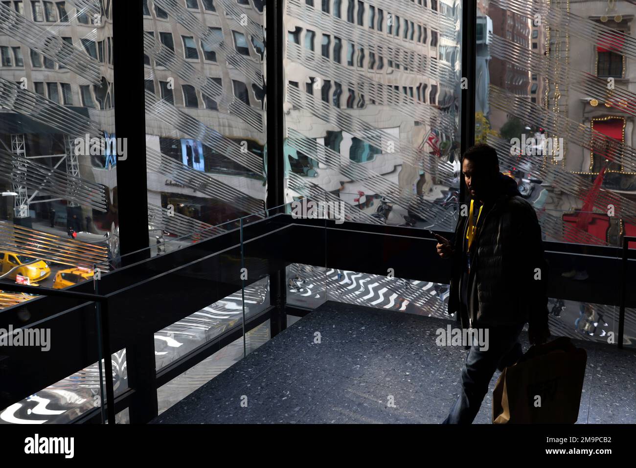 A shoppers walks up the stairs in a Nike store on Black Friday, Nov. 25 ...