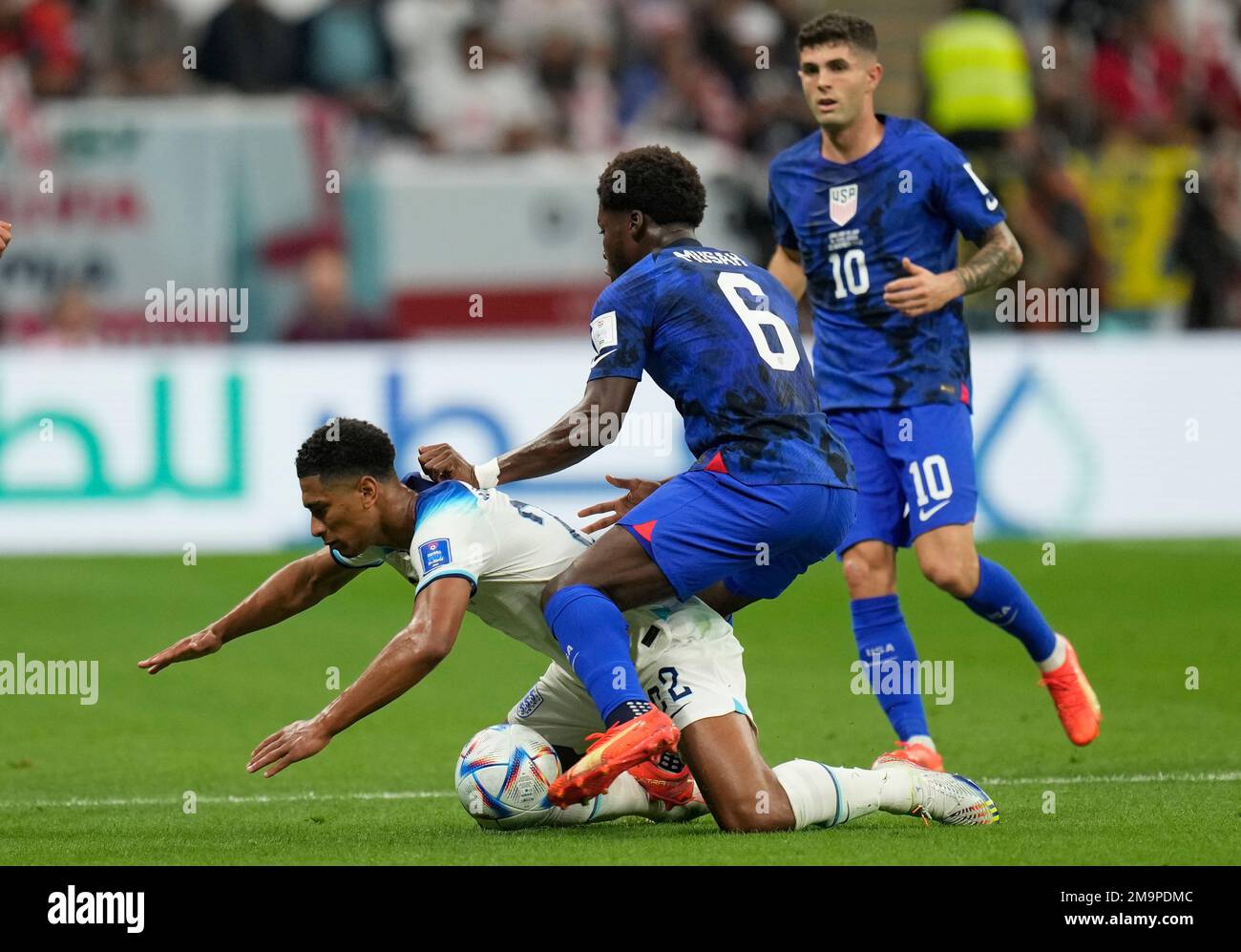 England's Jude Bellingham, left, challenges for the ball with Yunus ...