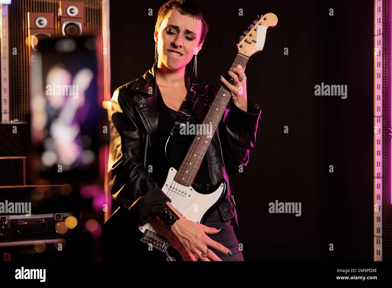 Rebel rockstar holding electric guitar playing heavy metal song ...