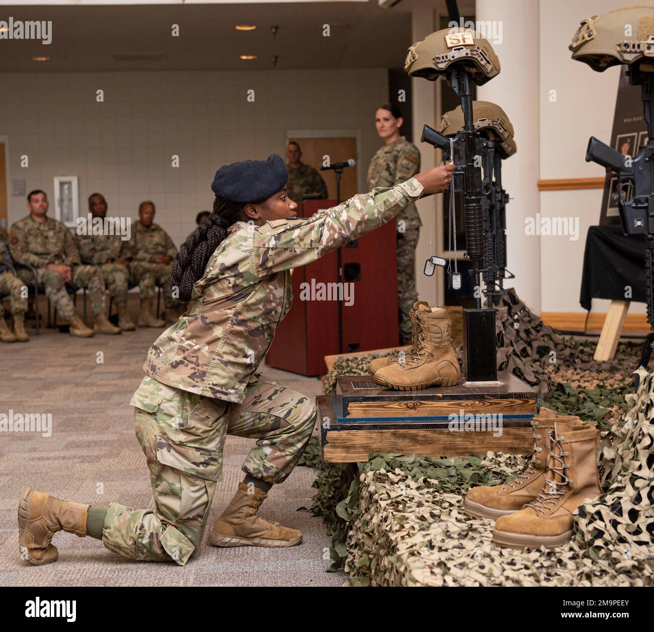 Members assigned to the 4th Security Forces Squadron place the dogtag of a fallen defender on a ...