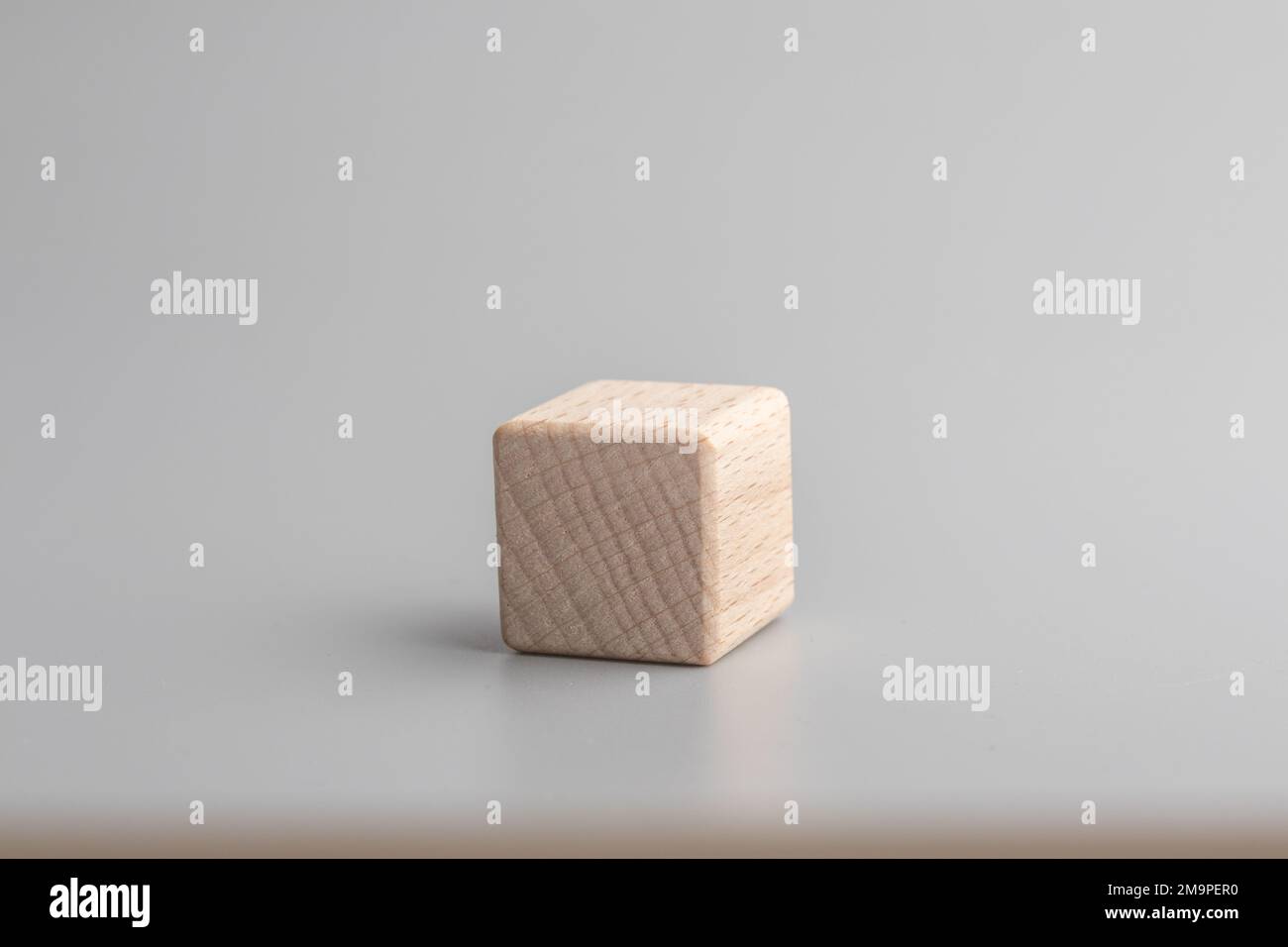 Simple empty wooden dice, one blank cubes made of wood with one central ...