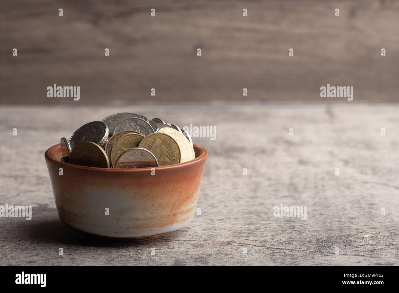 Coins in wooden cup.Future saving money concept.Copy space Stock Photo ...