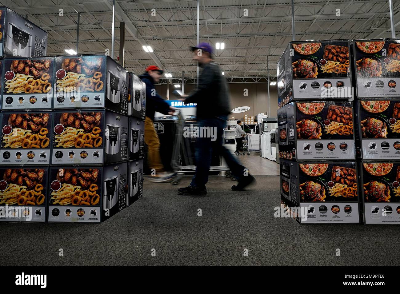 People pass a display of air fryers as they shop during a Black Friday ...