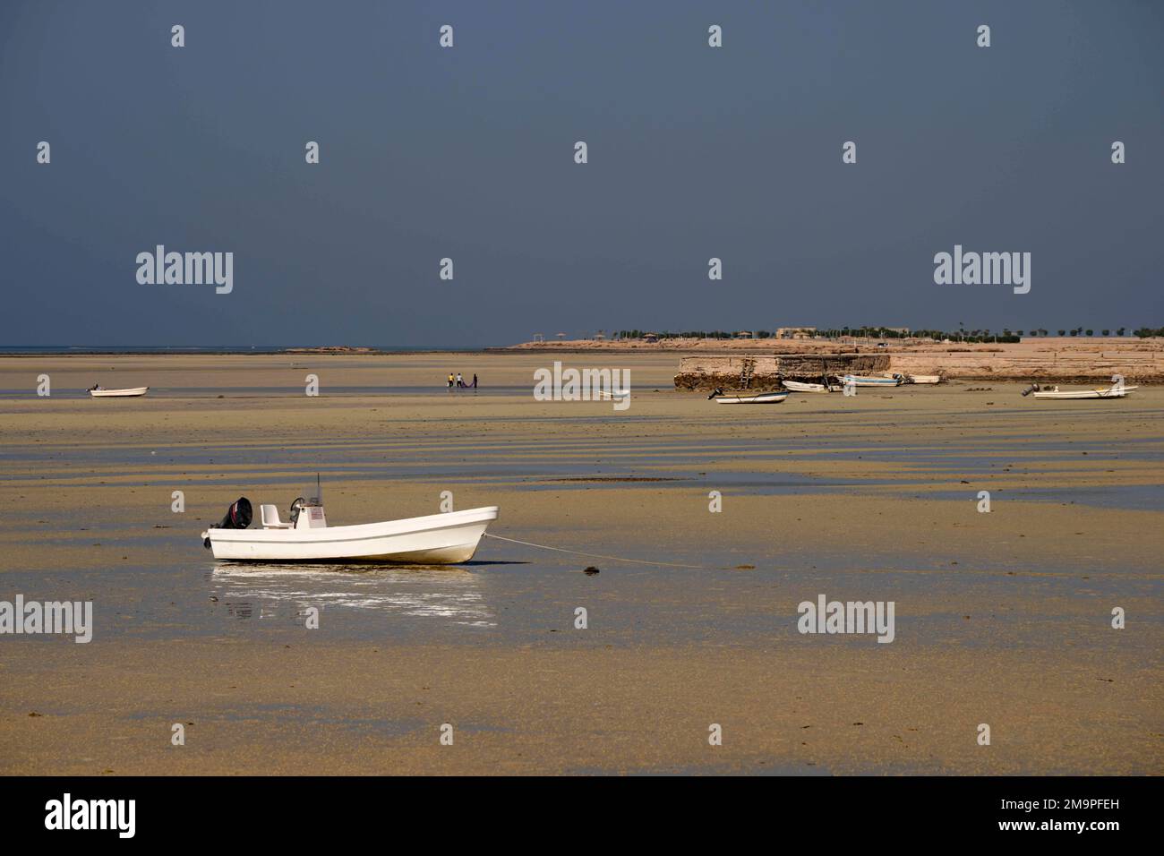 Boats grounded on the beach during low tide in Al-Ruwais, Qatar, Friday ...