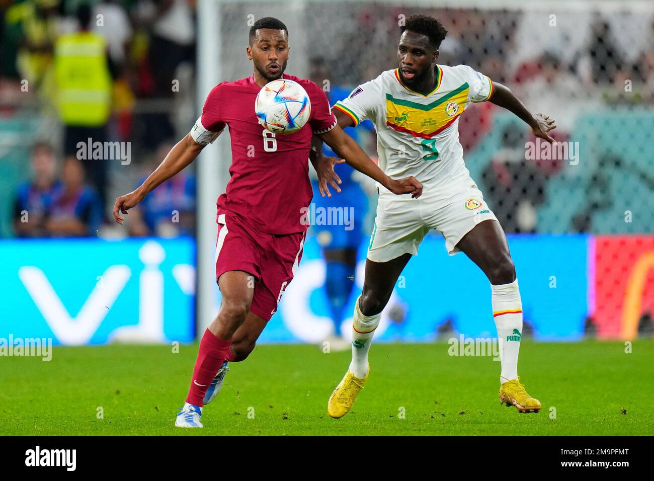 Qatar's Abdulaziz Hatem, left, and Senegal's Boulaye Dia fight for the ball during a World Cup ...