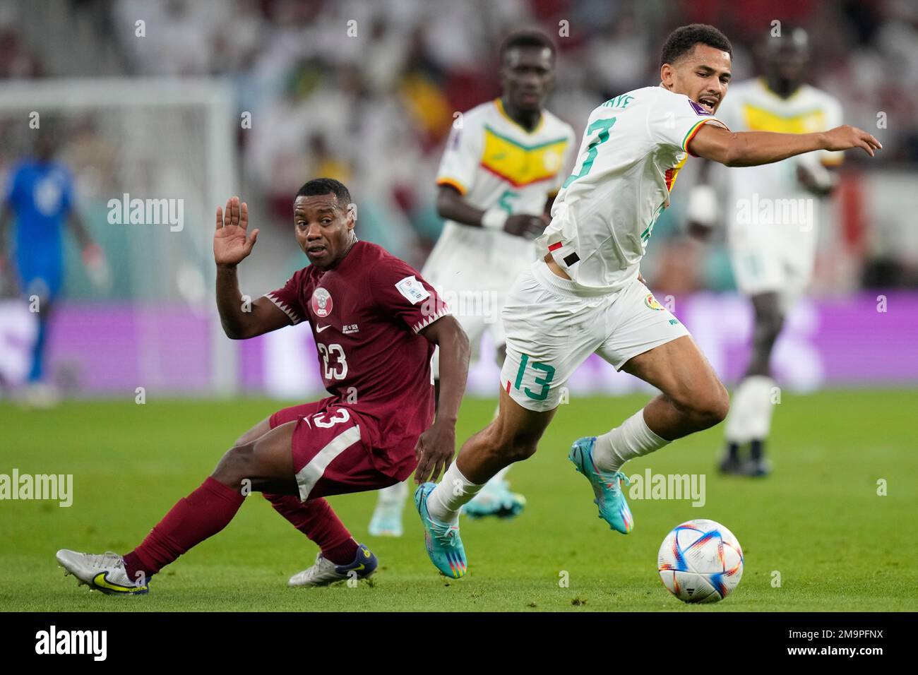 Senegal's Ismail Jakobs, right, dribbles past Qatar's Assim Madibo ...