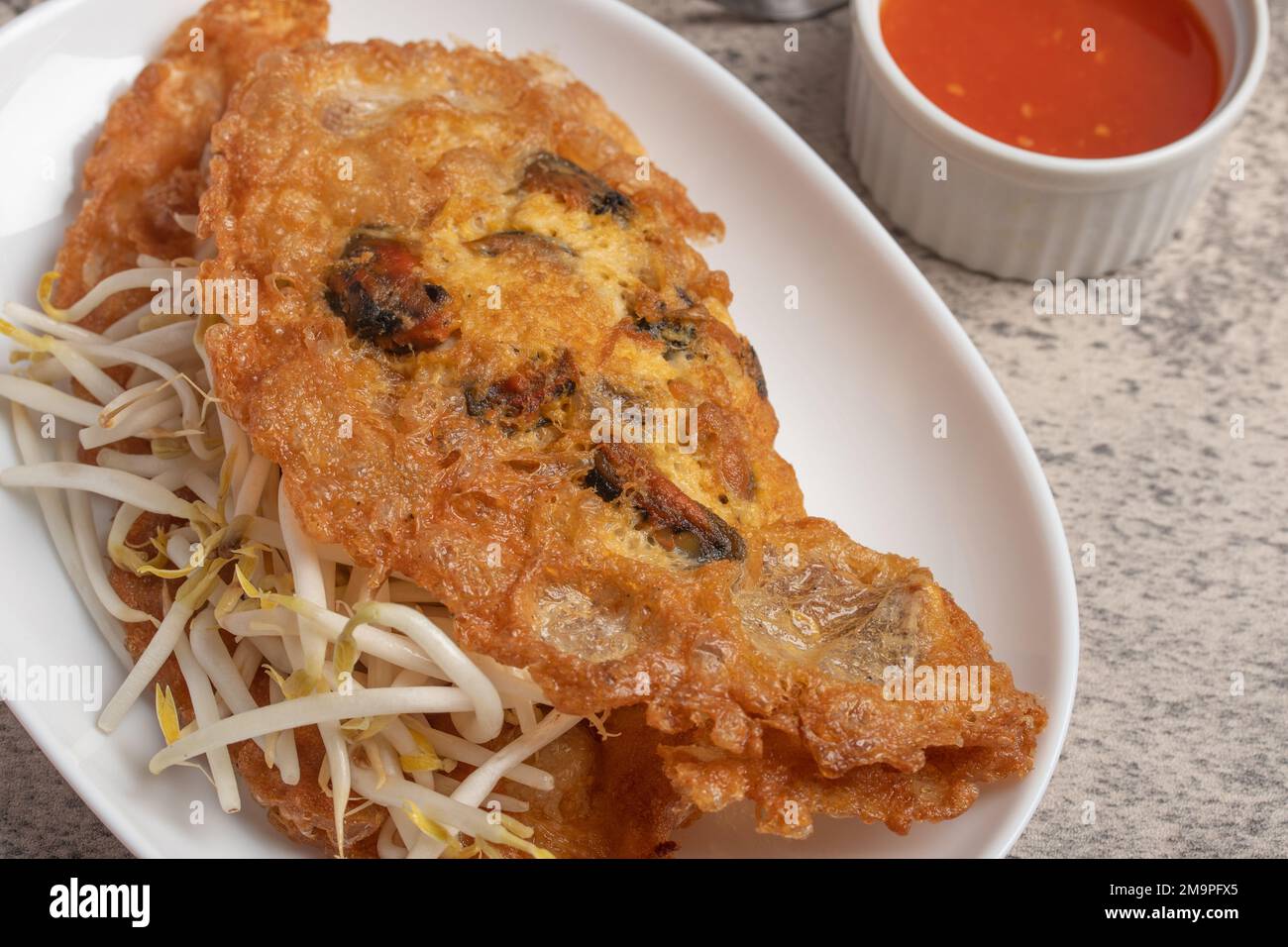 Fried mussels in crispy batter in a white plate Stock Photo - Alamy