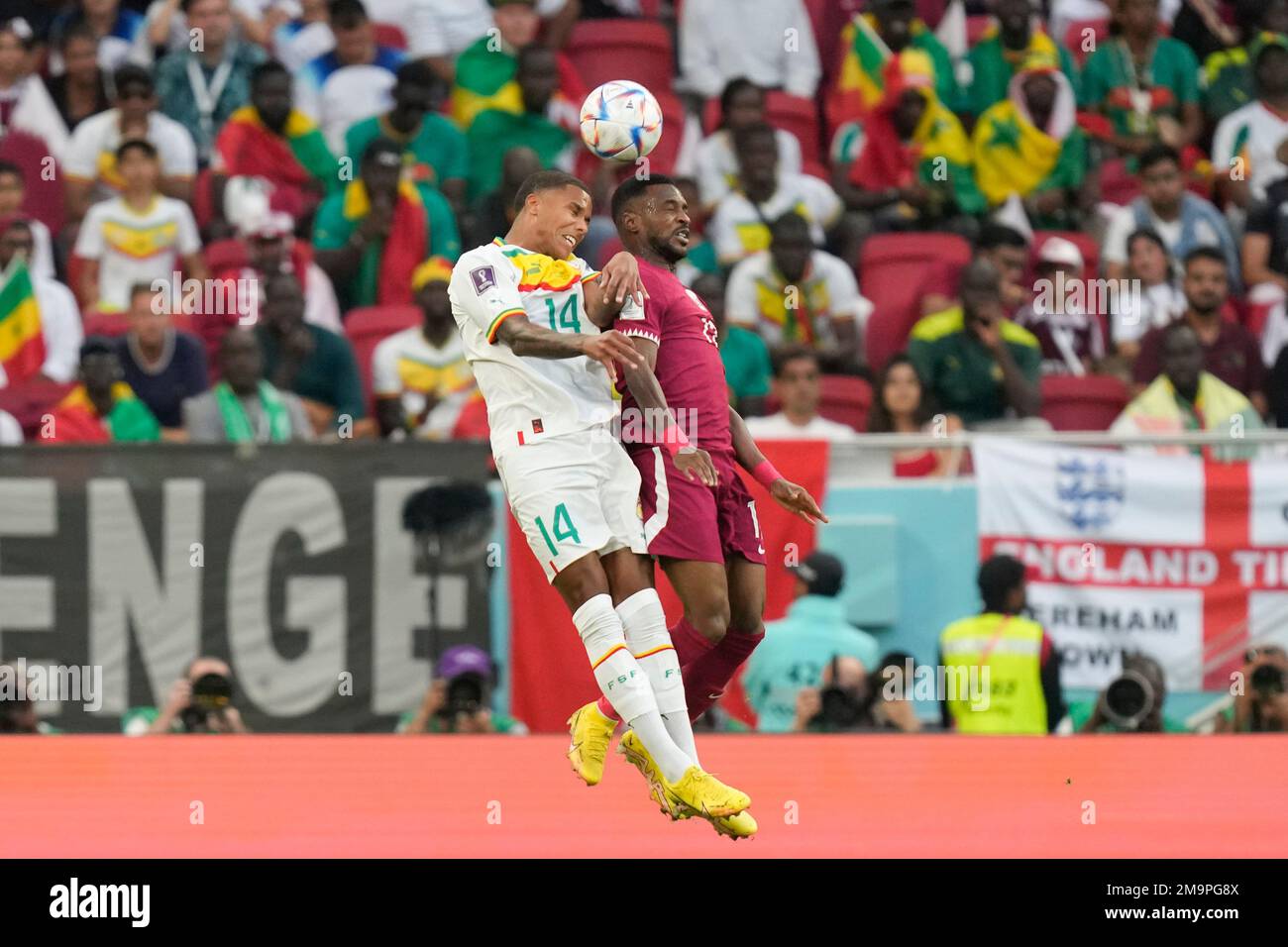 Senegal's Formose Mendy, left, and Qatar's Ismail Mohamad go for a ...