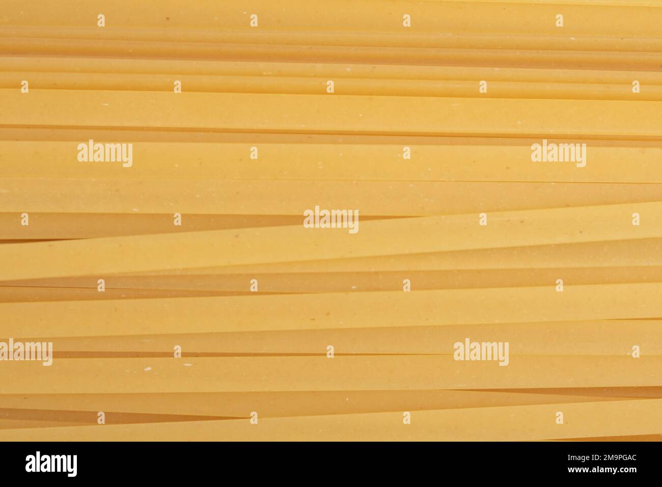 Yellow pasta lines for background.Close up Stock Photo - Alamy