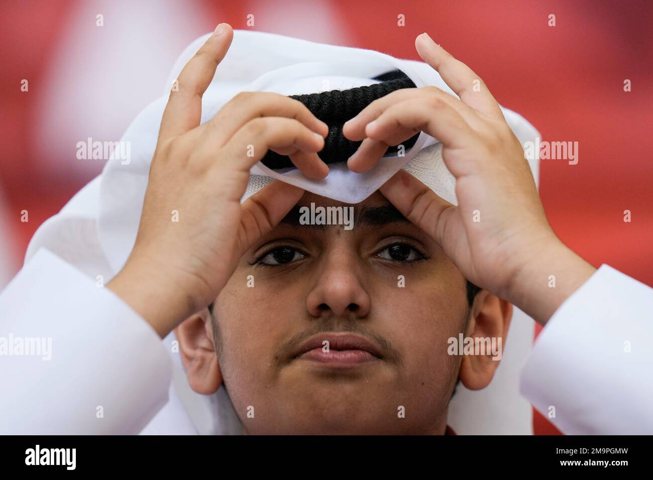 A Qatar fan adjusts his gutra before the World Cup group A soccer match ...