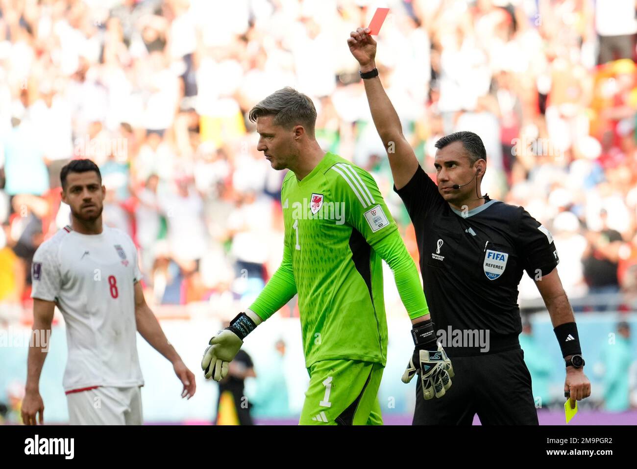 Referee Mario Alberto Escobar, right, shows a red card to Wales ...