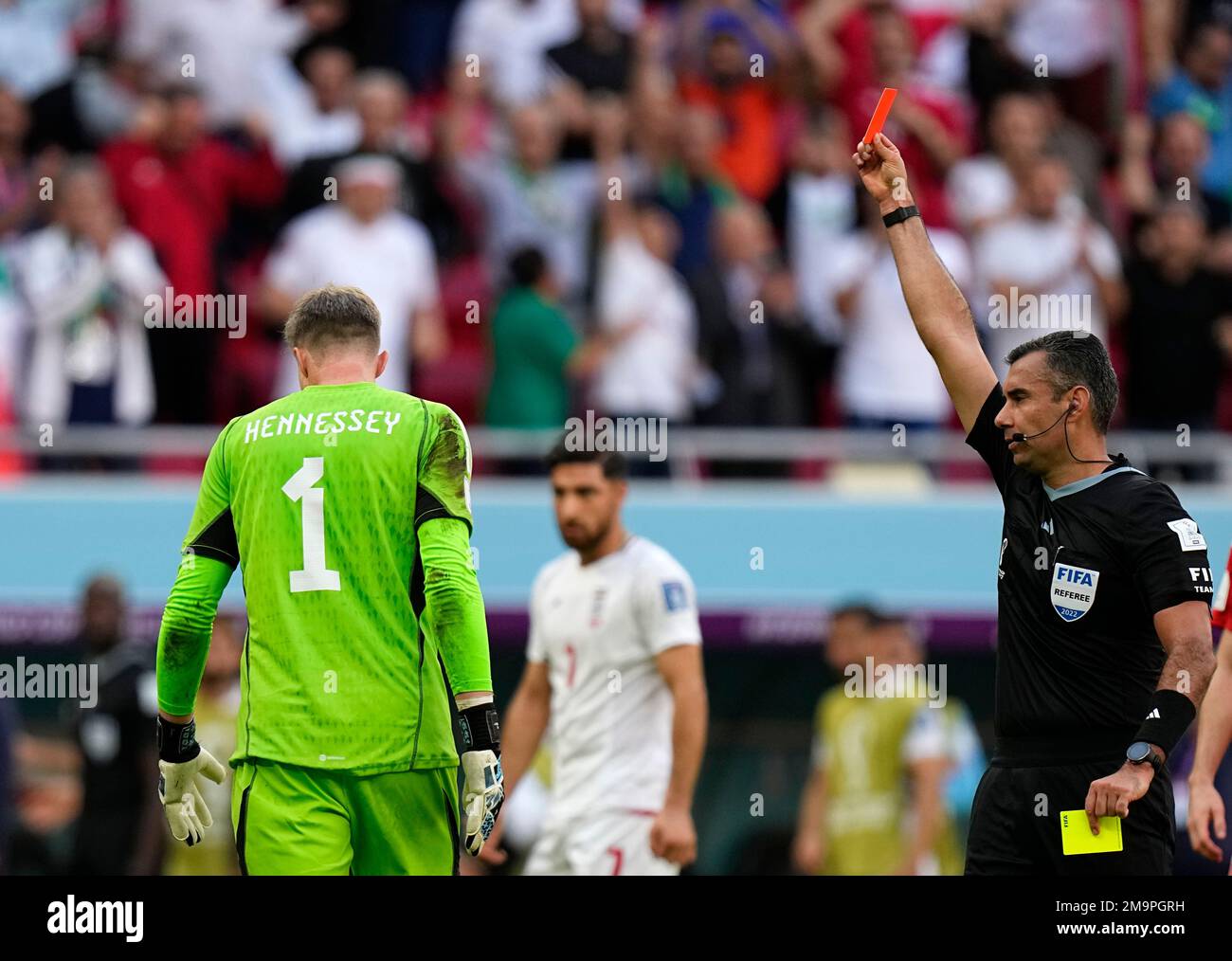 Referee Mario Alberto Escobar Toca, right, shows a red card to Wales ...