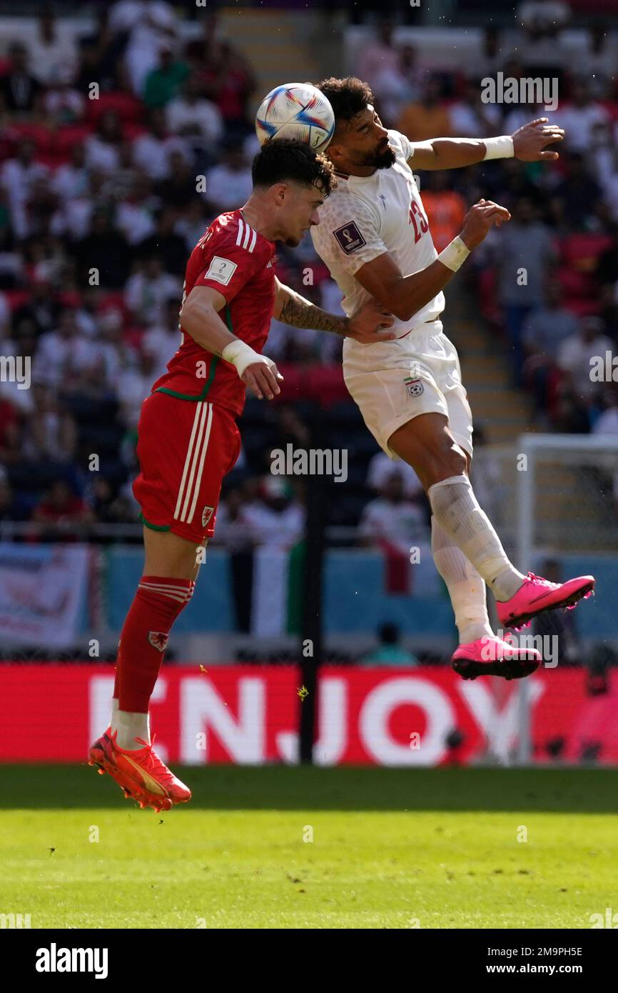 Iran's Ramin Rezaeian, right, and Wales' Neco Williams reach for a ...