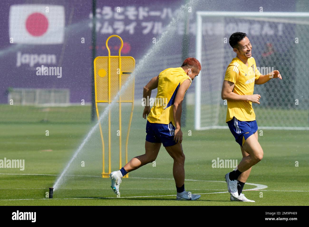 Japan's Maya Yoshida, right, and Yuto Nagatomo, left, avoid getting wet ...