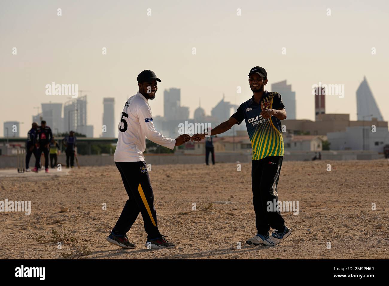 People play cricket in the streets in Doha, Qatar, Friday, Nov. 25 ...