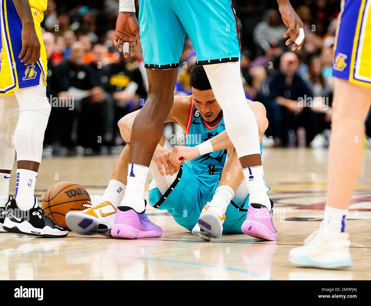 Phoenix Suns' Devin Booker (1) takes a breather after getting fouled by Los Angeles Lakers ...