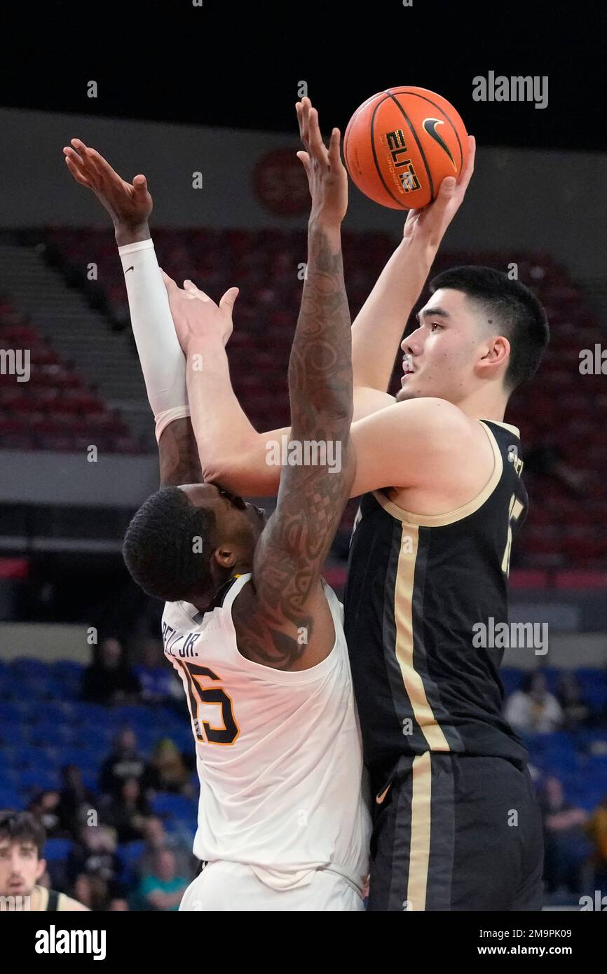 Purdue center Zach Edey, right, shoots against West Virginia forward Jimmy Bell Jr. (15) during ...