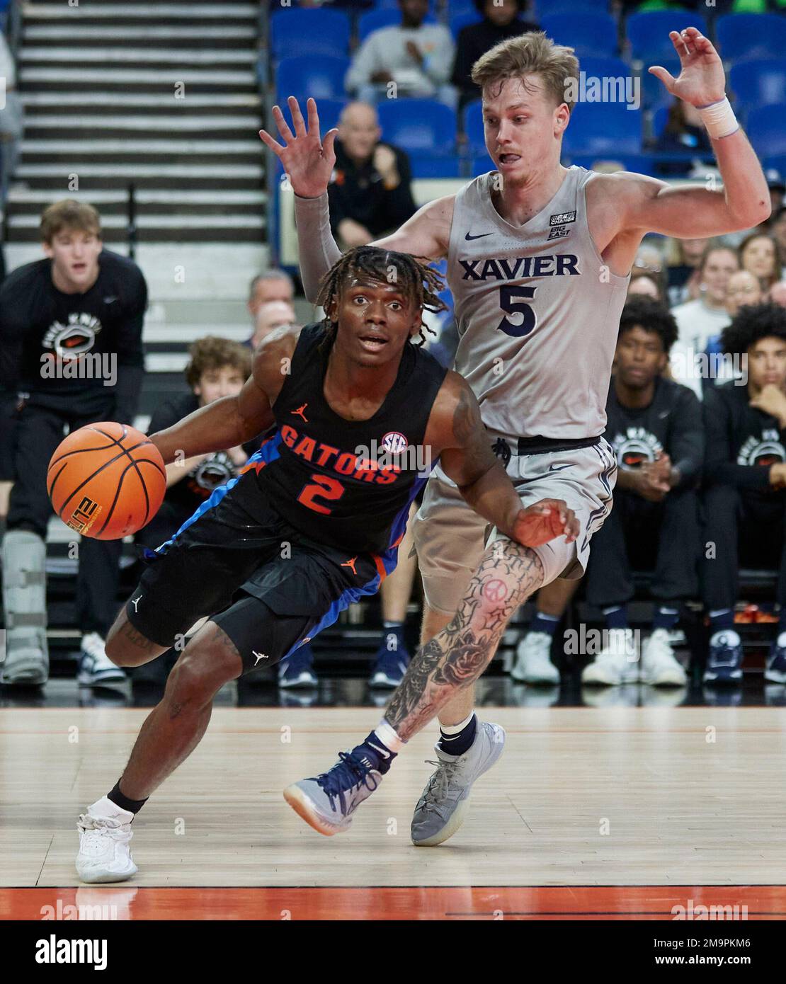 Florida guard Trey Bonham, left, drives around Xavier guard Adam Kunkel ...