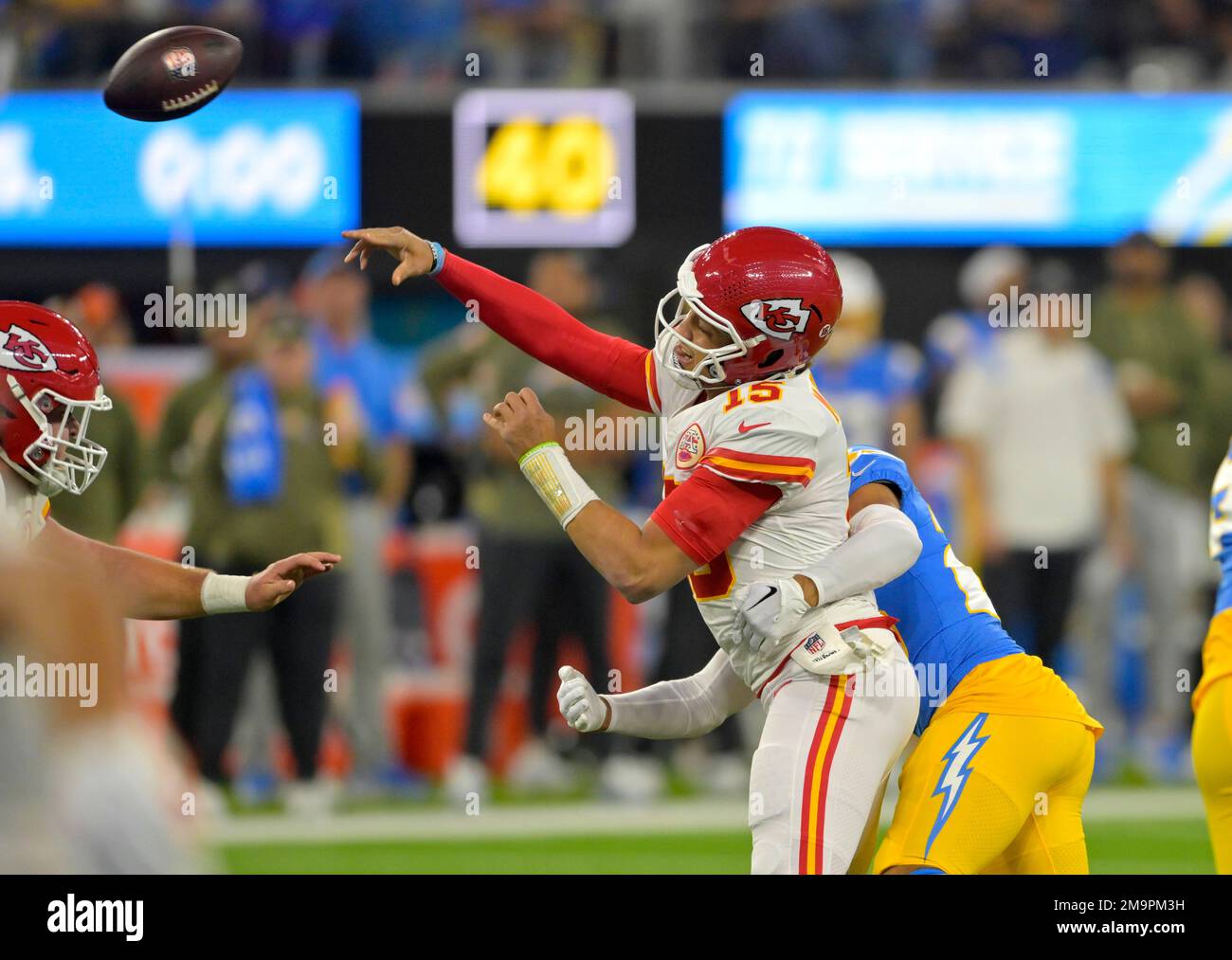 Kansas City Chiefs quarterback Patrick Mahomes, left, throws under ...