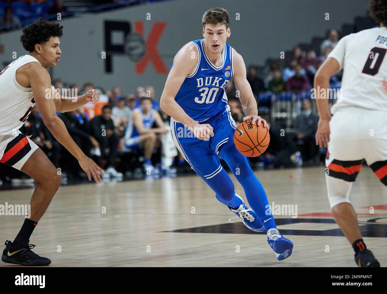 Duke center Kyle Filipowski, right, dribbles towards Oregon State ...