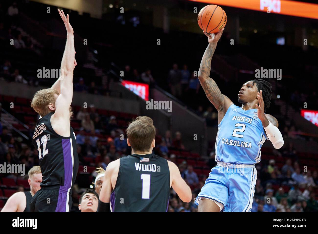 North Carolina guard Caleb Love, right, shoots over Portland forward ...