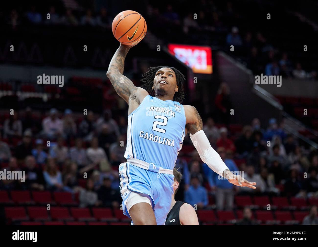 North Carolina guard Caleb Love goes up for a dunk against Portland ...