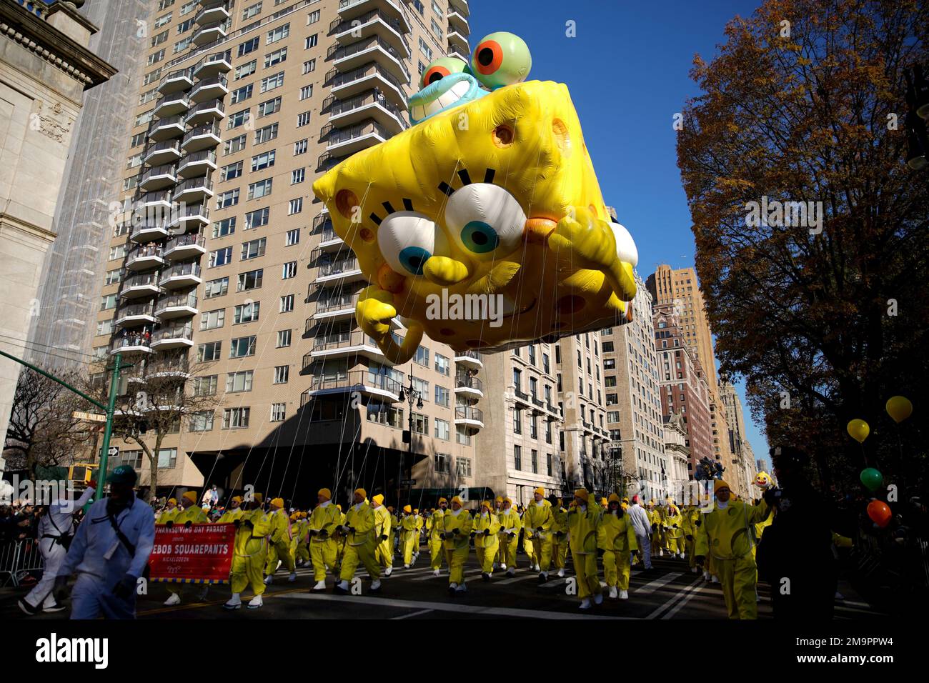 Handlers pull the Spongebob Squarepants balloon along Central Park West ...