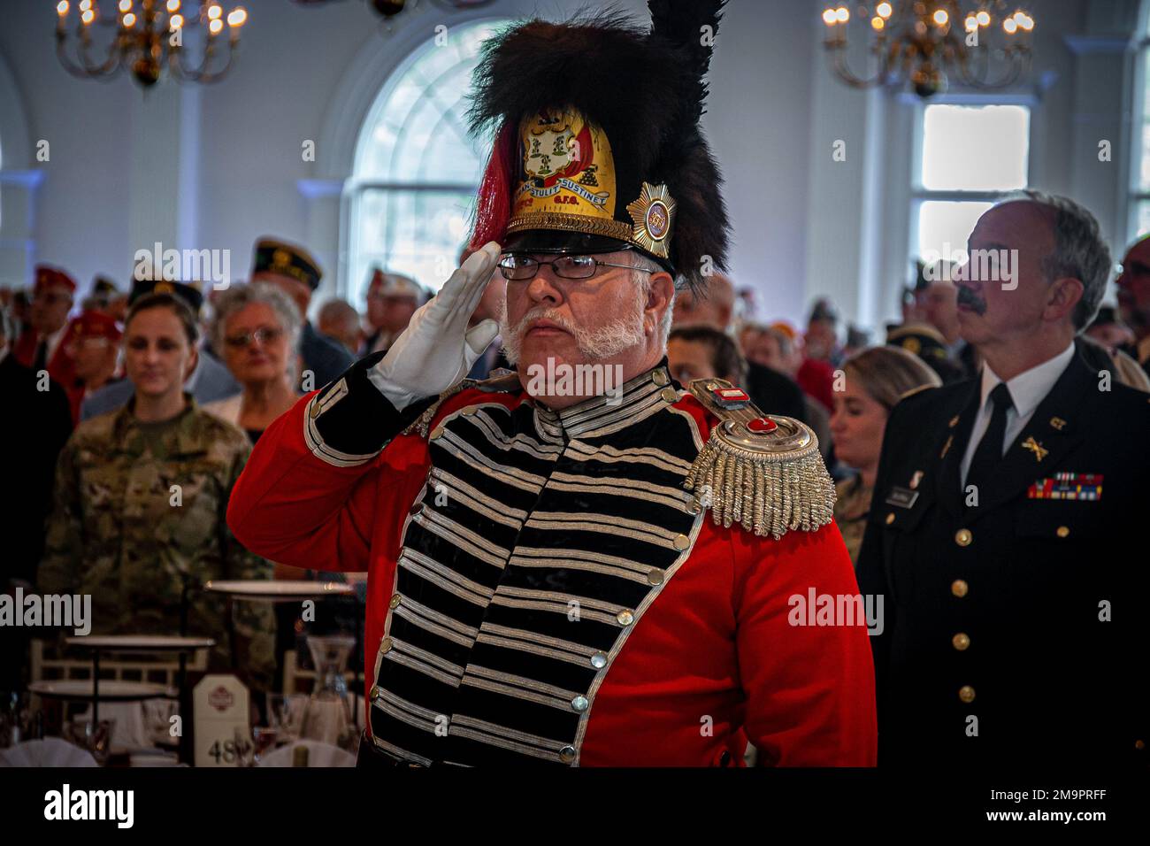 A member of the 1st Company Governor's Foot Guard salutes as the colors ...
