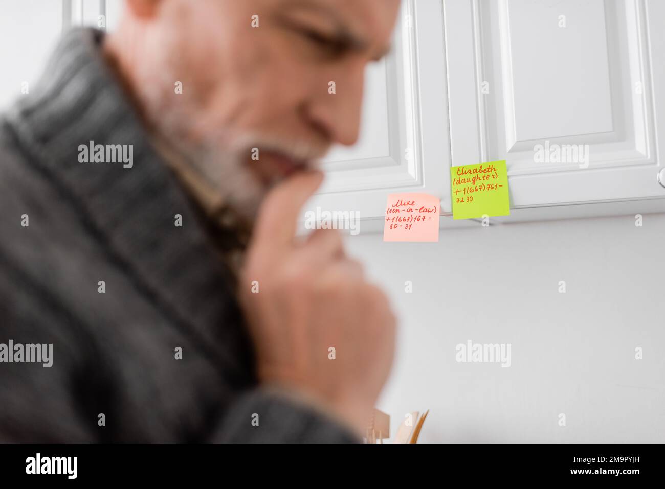 blurred thoughtful man with memory loss touching chin while thinking ...