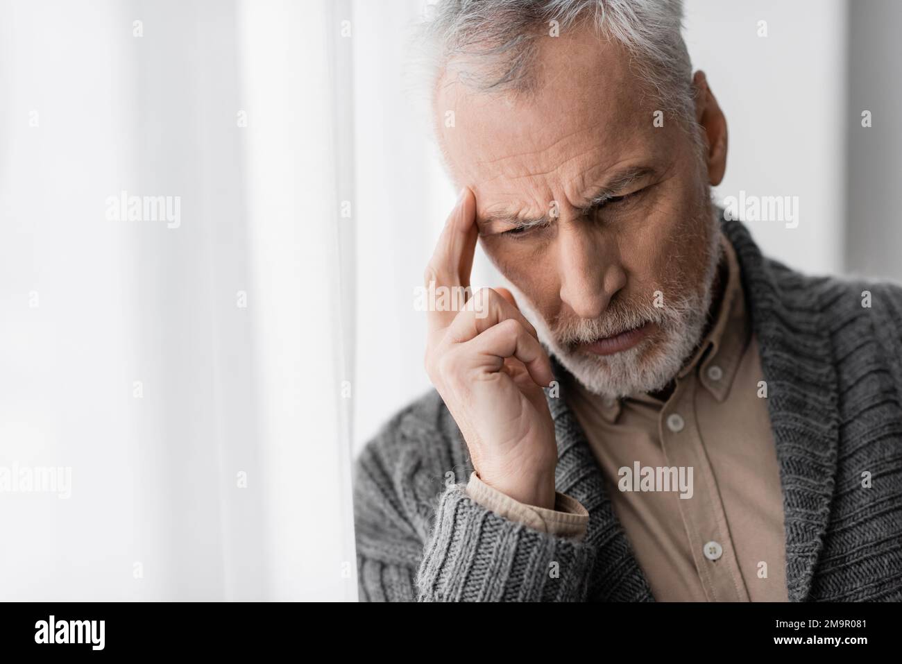 grey haired man suffering from memory loss and alzheimer disease ...