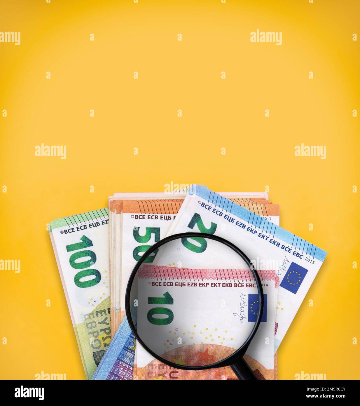 Pack of euro banknotes (10, 20, 50, 100) on yellow background. European ...