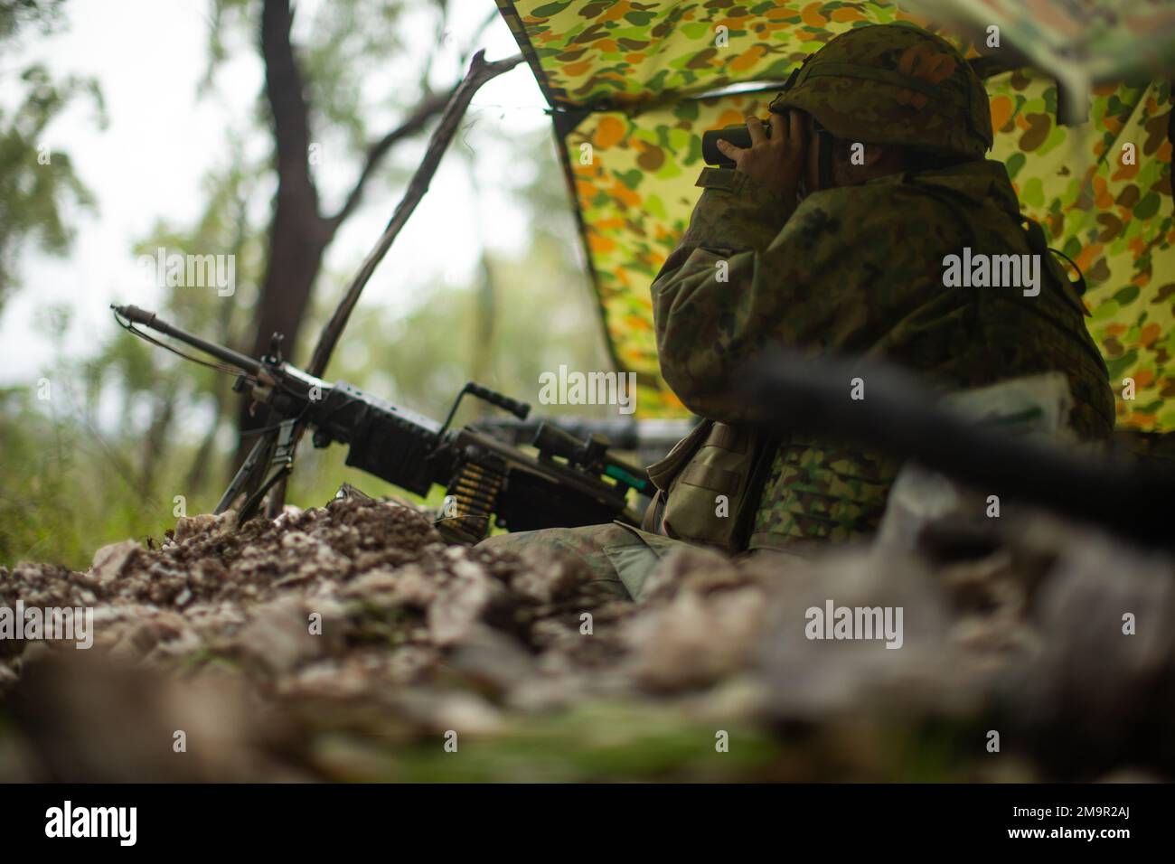 A Japan Ground Self-Defense Force (JGSDF) soldier surveys the training ...