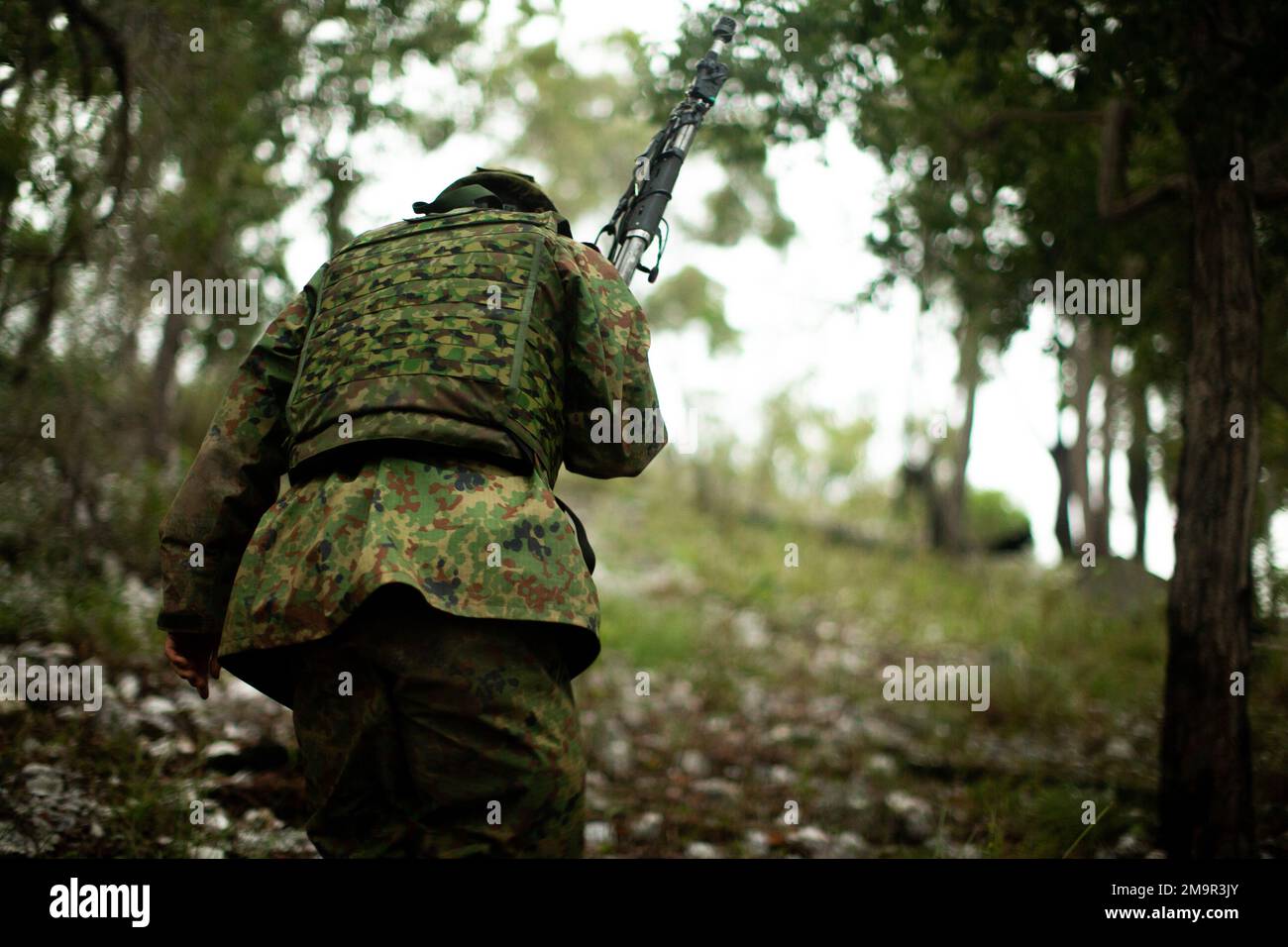 A Japan Ground Self-Defense Force (JGSDF) soldier walks to his position ...