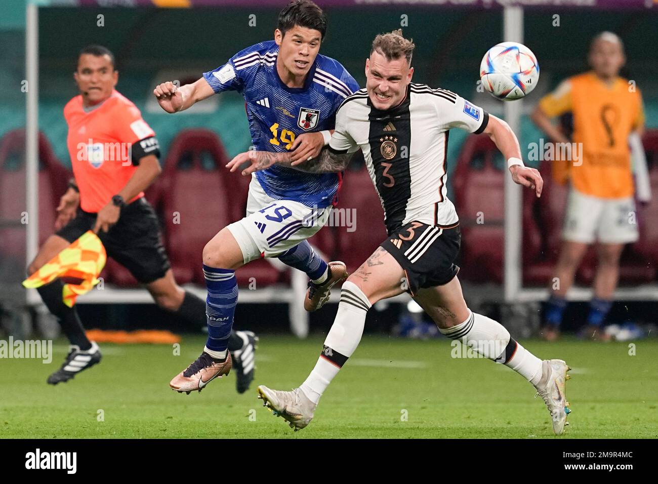 Japan's Hiroki Sakai, left, and Germany's David Raum fight for the ball ...
