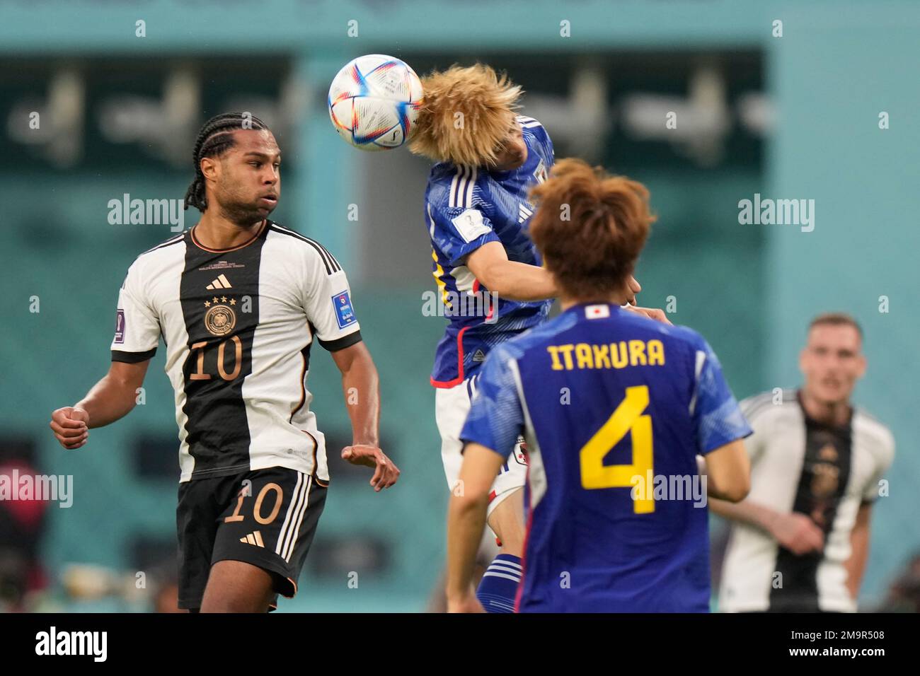 Japan's Junya Ito, top right, heads the ball past Germany's Serge ...
