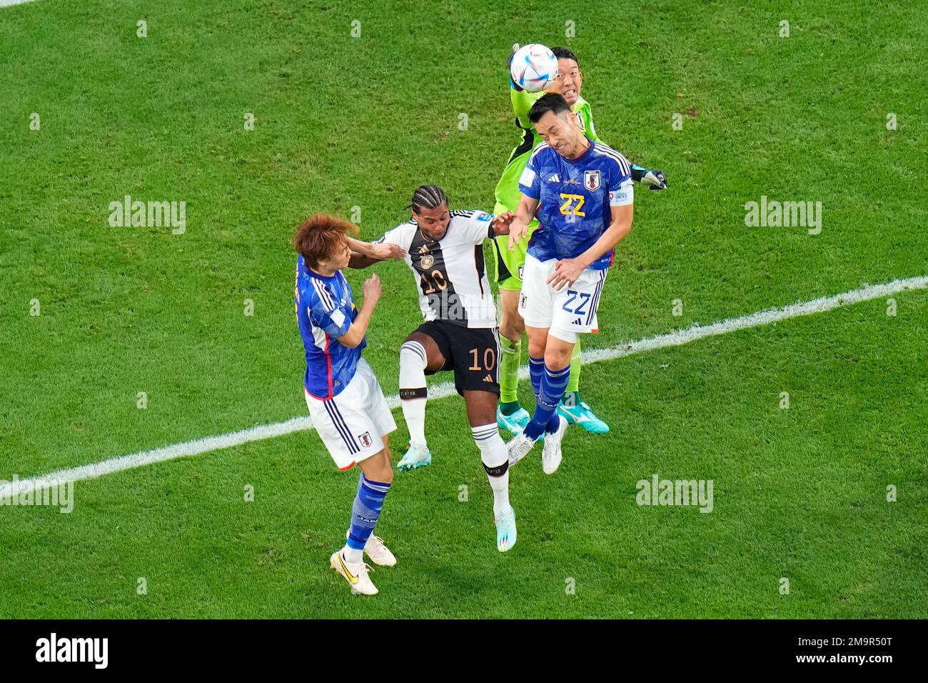 Japan's goalkeeper Shuichi Gonda makes a save above Japan's Maya ...