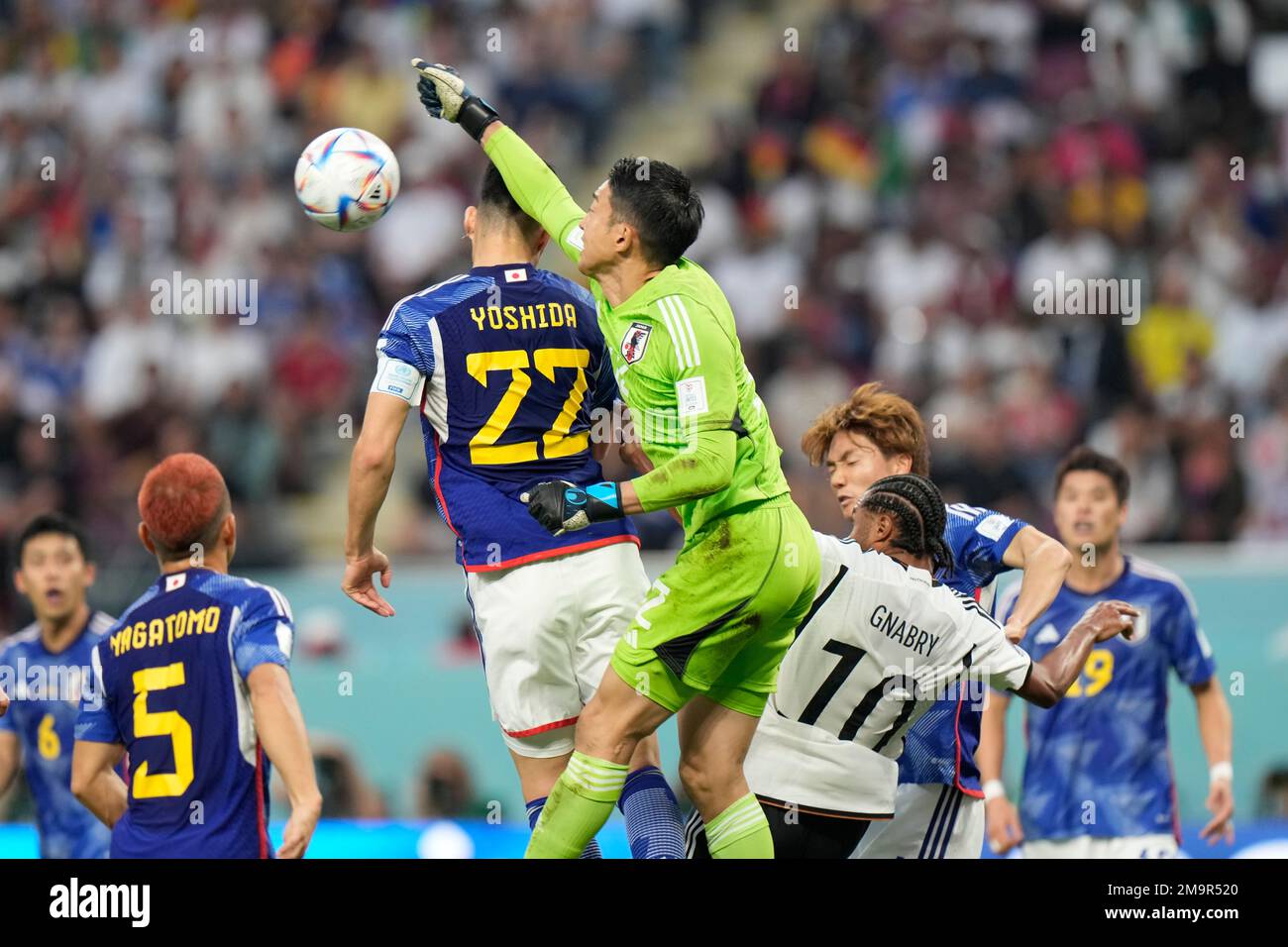 Japan's goalkeeper Shuichi Gonda, right, clears the ball during the ...