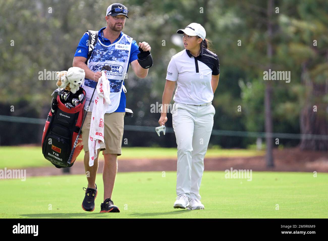 Ruoning Yin, right, of China, and her caddie walk on the fifth fairway ...