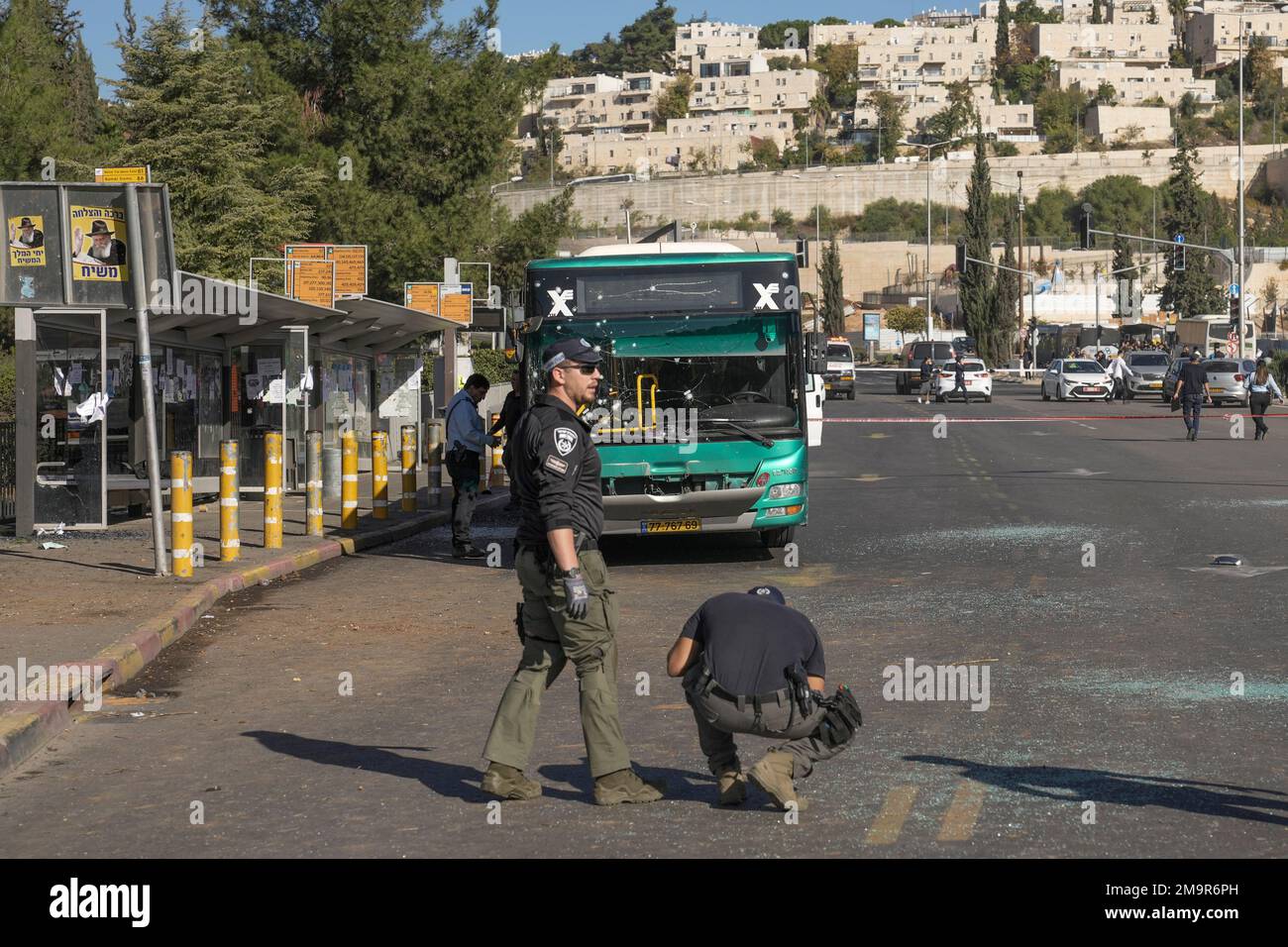 Israeli police inspect the scene of an explosion at a bus stop in ...