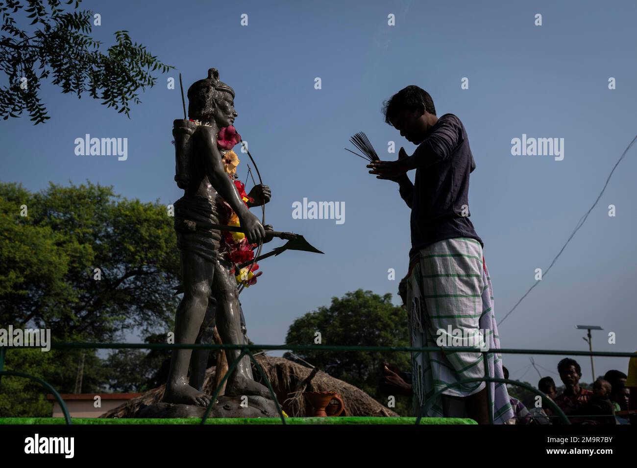 A tribesman prays in front of the statue of Birsa Munda, a 19th-century ...