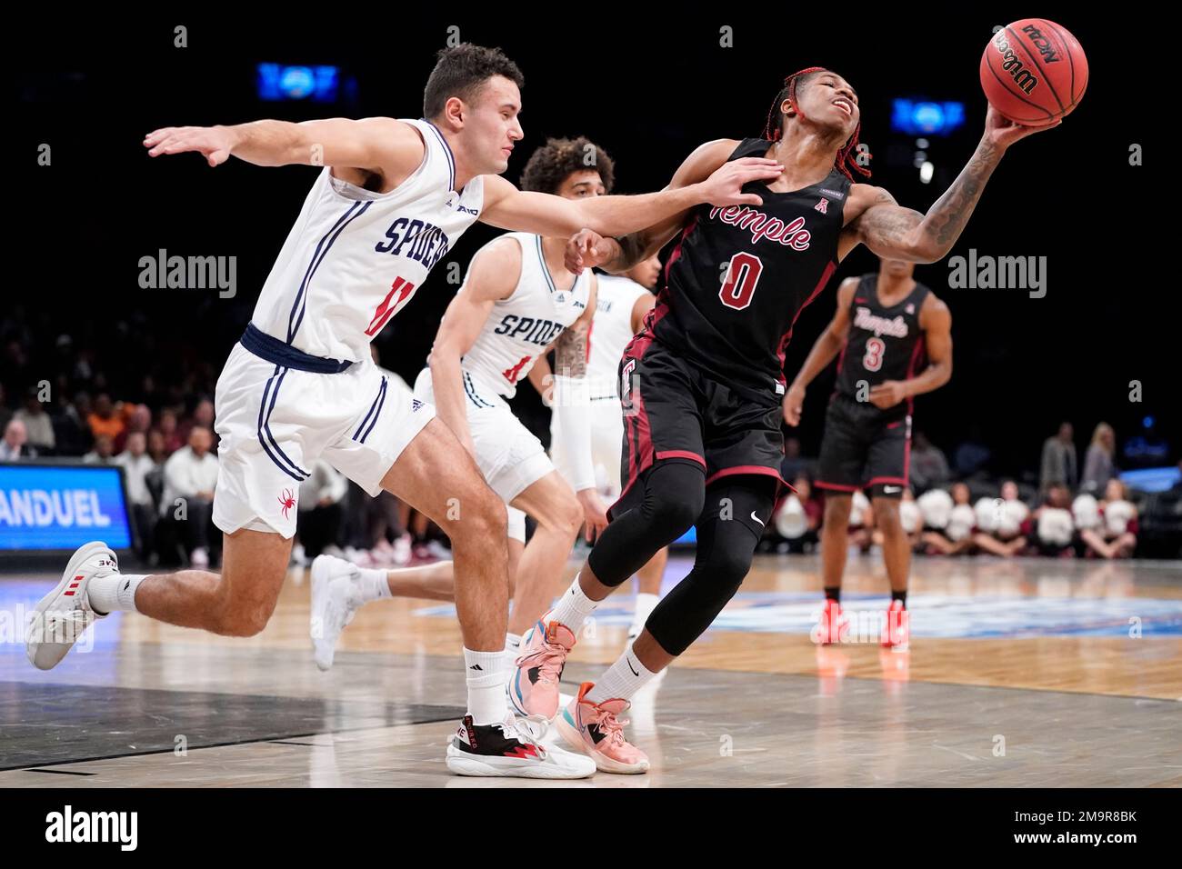 Temple's Khalif Battle (0) passes against Richmond's Jason Roche (11 ...