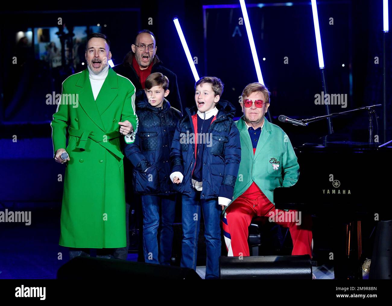 Elton John is joined by his children, husband David Furnish, left, and ...