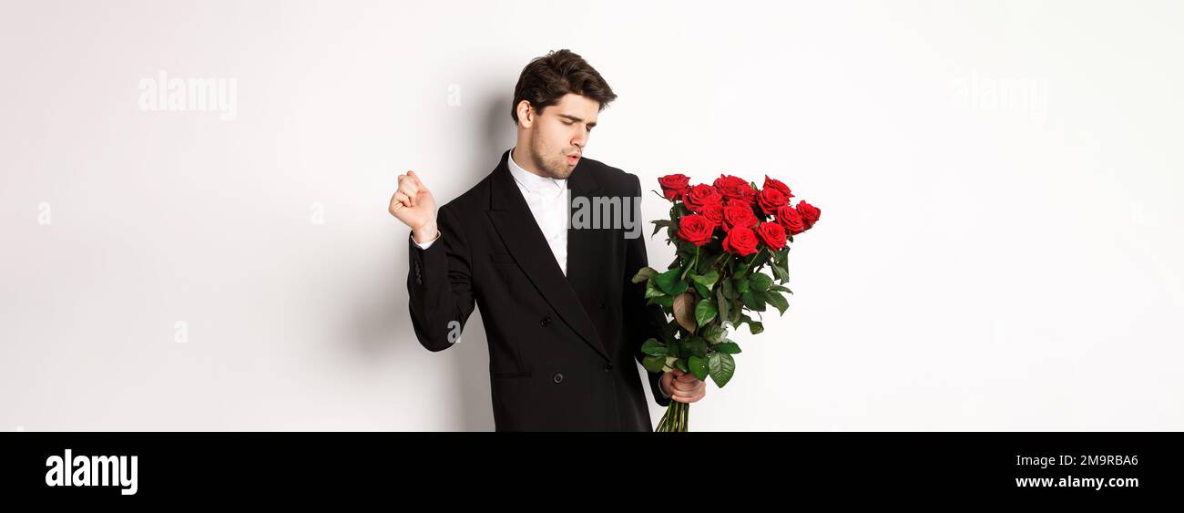Image of elegant and sassy man in black suit, looking confident and ...