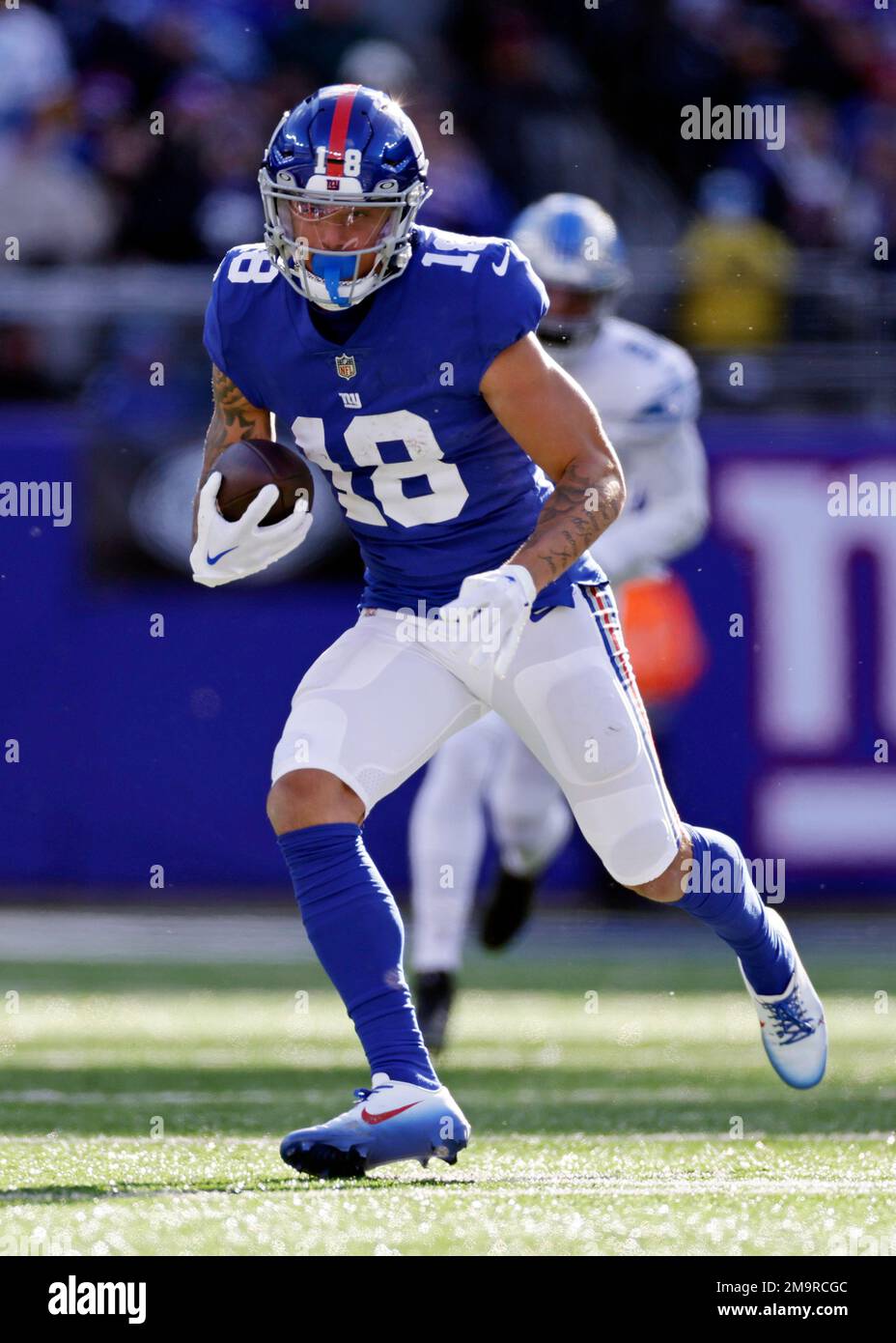 New York Giants wide receiver Isaiah Hodgins (18) runs with the ball ...