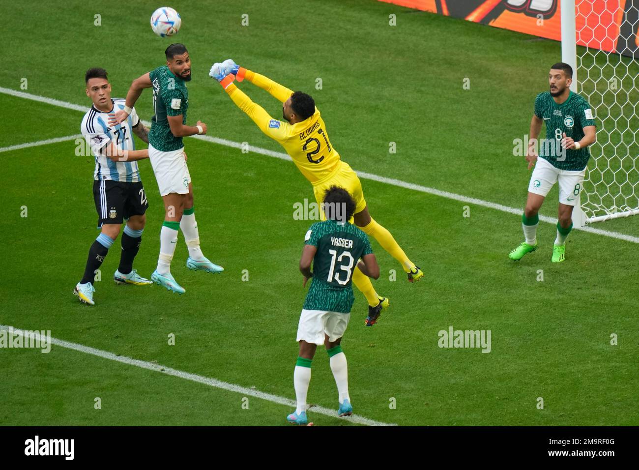 Saudi Arabia's goalkeeper Mohammed Al-Owais reaches out to the ball to ...