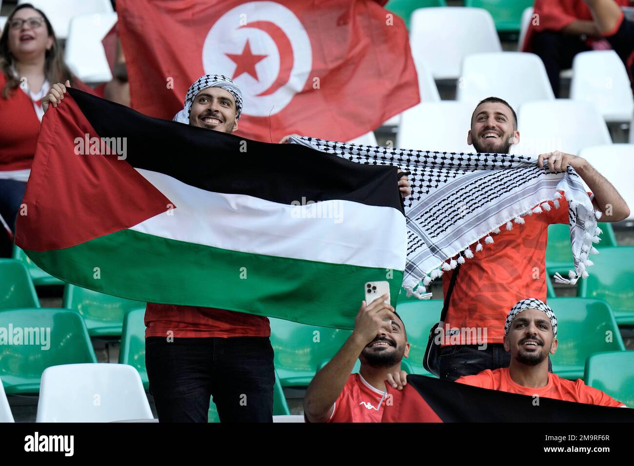 A soccer supporter waves a flag of Palastine before the start of the ...